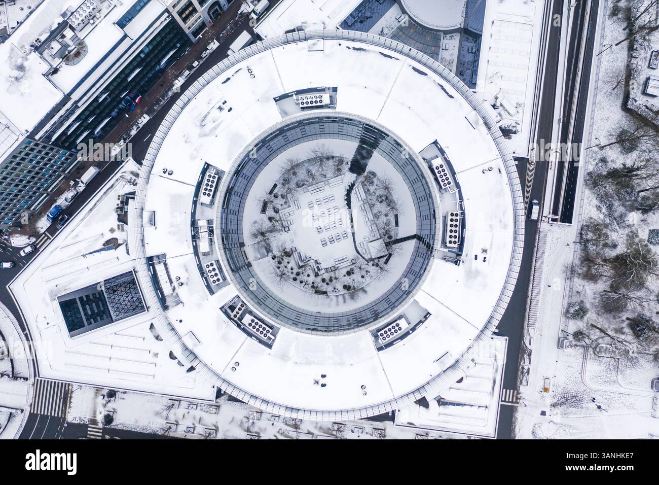 Aerial view of a circular European Union building under the snow at ...