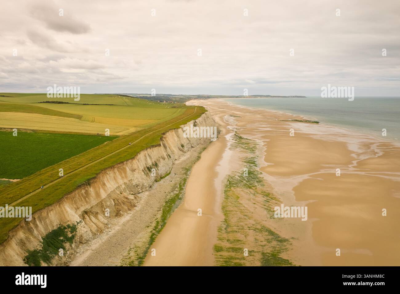 Aerial view of a beautiful landscape with wild cliffs and a white sandy ...