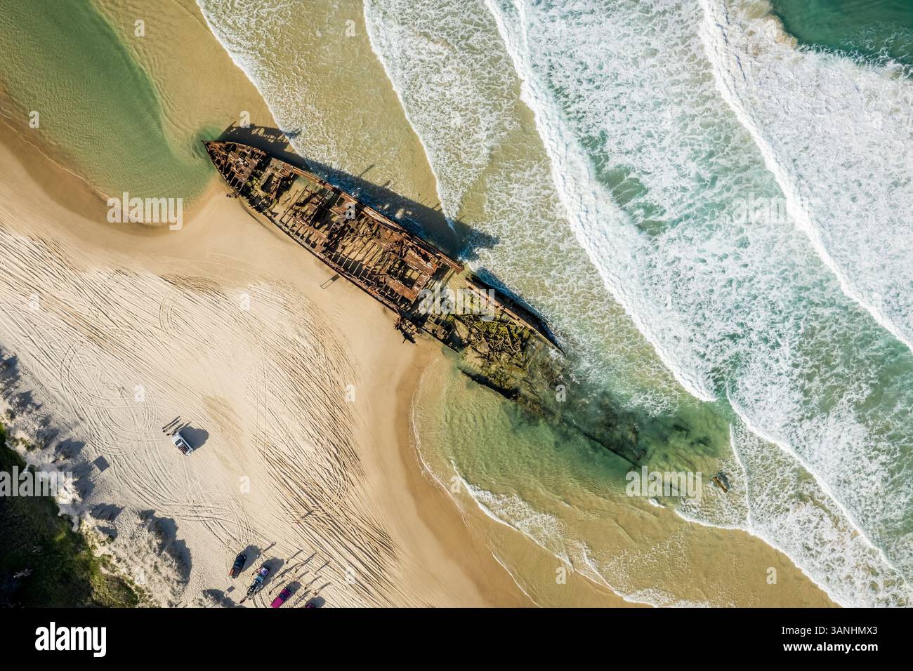 Aerial view of a few tourists looking at S.S. Maheno, a ship wreck beached on Fraser Island ...