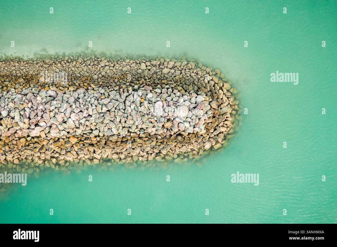 Aerial view of breakwater structure along Cannonvale harbour and city ...