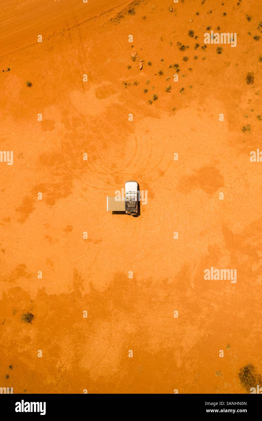 Aerial view of two people camping in the desert with theirs off road ...