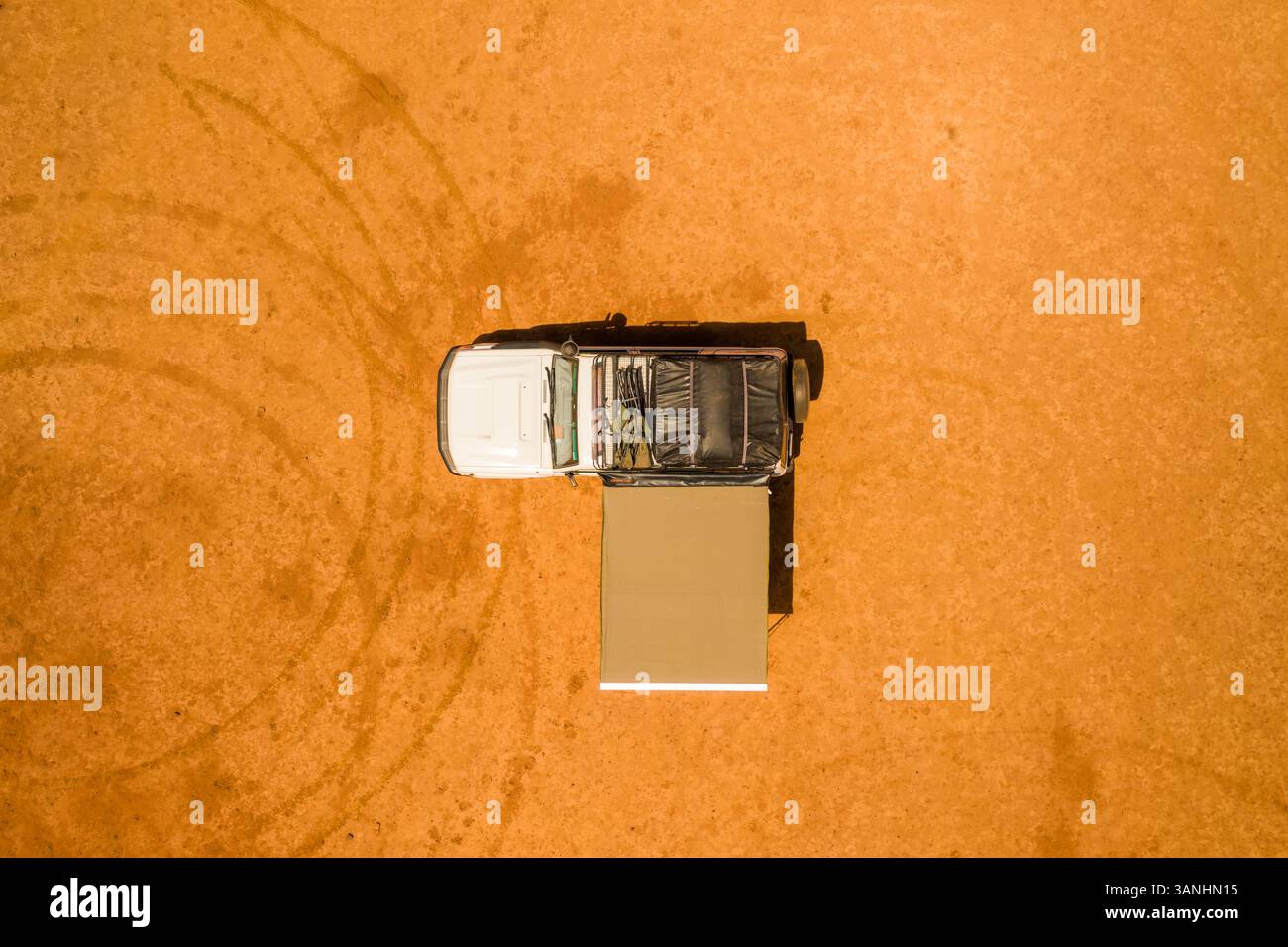 Aerial view of two people camping in the desert with theirs off road ...