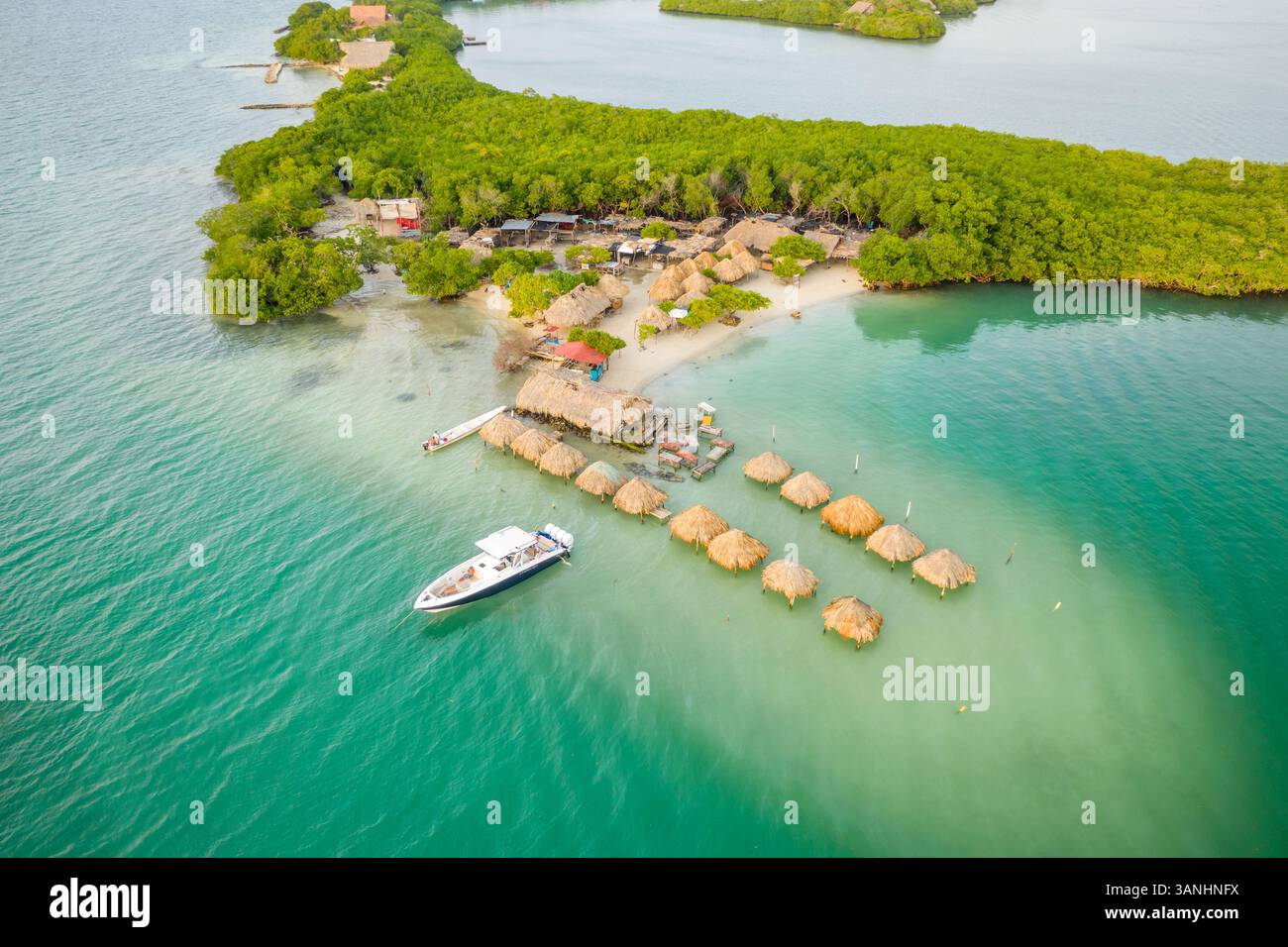 Aerial view of a luxury resort huts with palafitte and a small sailing ...