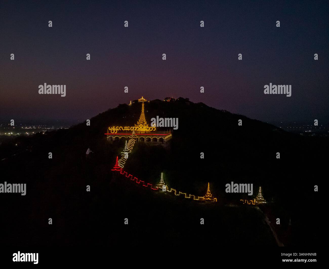Aerial view of Shweyattaw buddha temple on the hill at night with the ...
