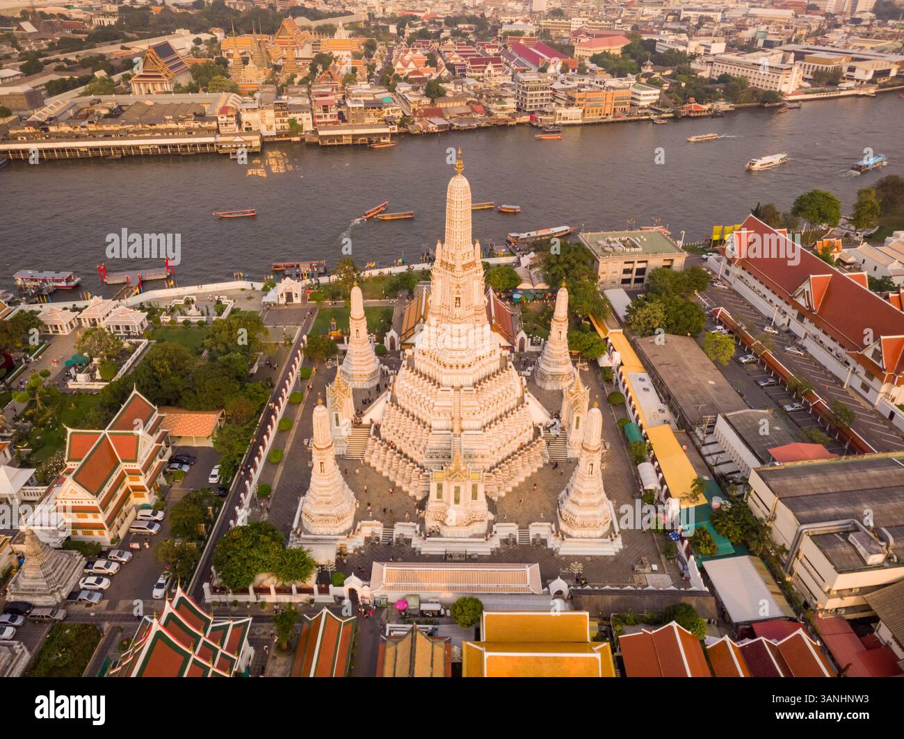 Aerial view of Wat Arun Pagoda along the Chao Phraya river at sunset ...