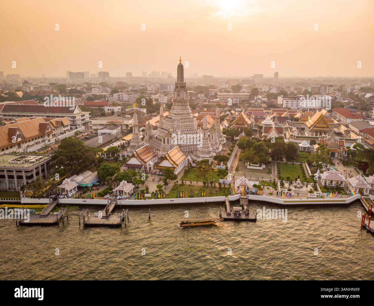 Aerial view of Wat Arun Pagoda along the Chao Phraya river at sunset ...