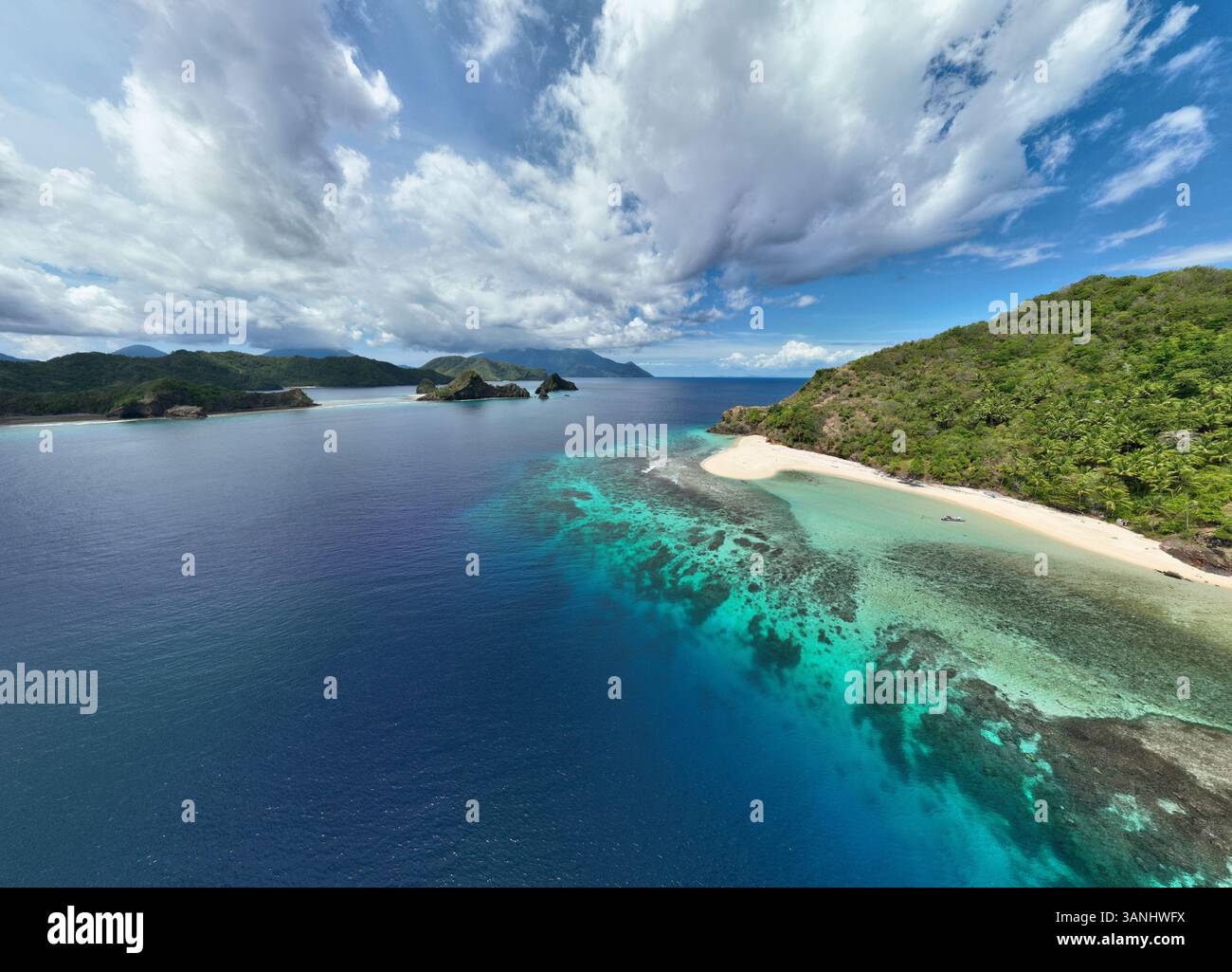 Aerial View of pristine beach and healthy coral reef on Mahoro Island ...