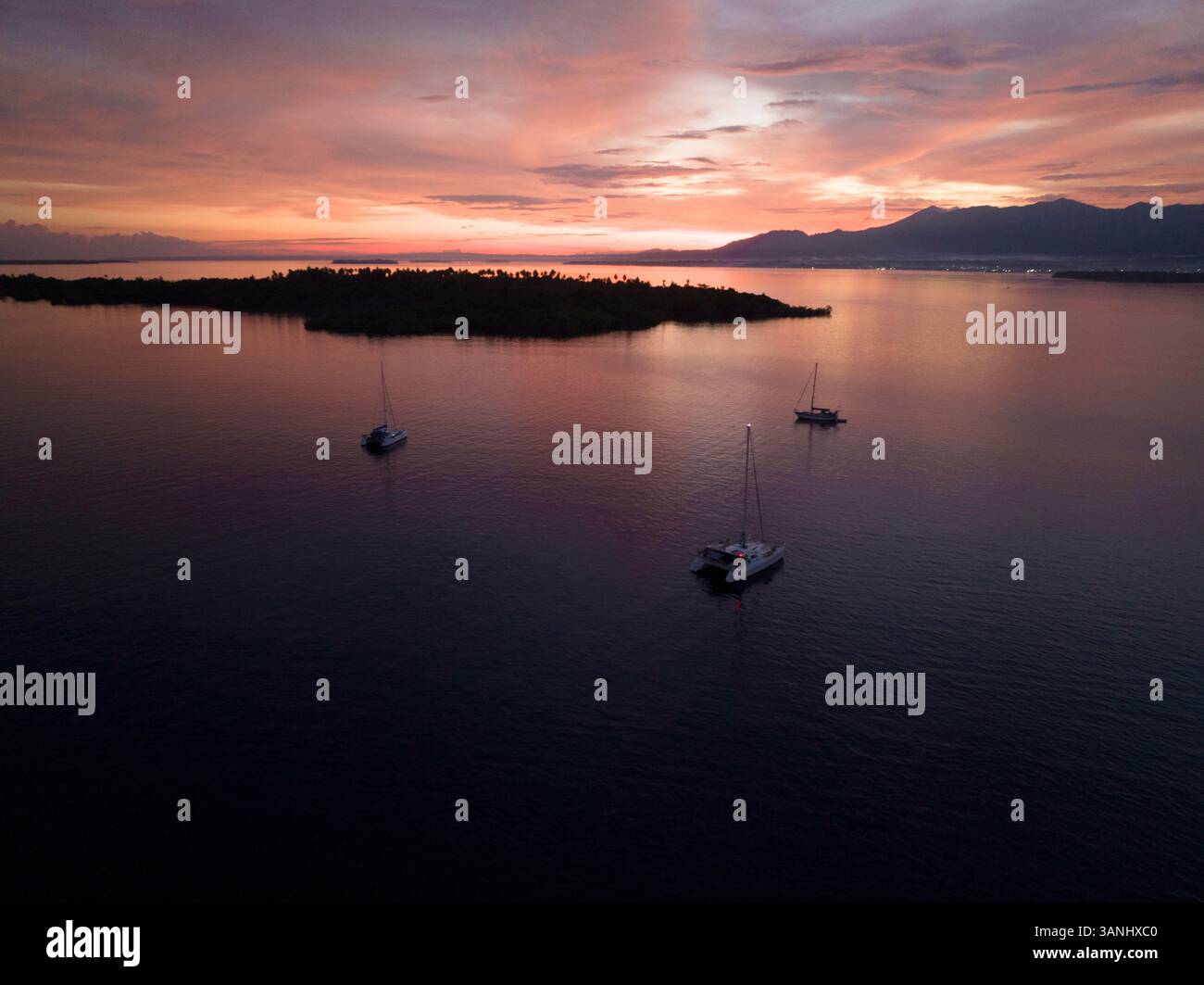 Aerial view of sailing vessels during golden hour anchoring near Tobelo ...