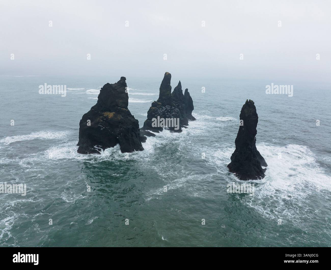 Aerial view of Reynisdrangar rocks, basalt sea stacks situated under ...
