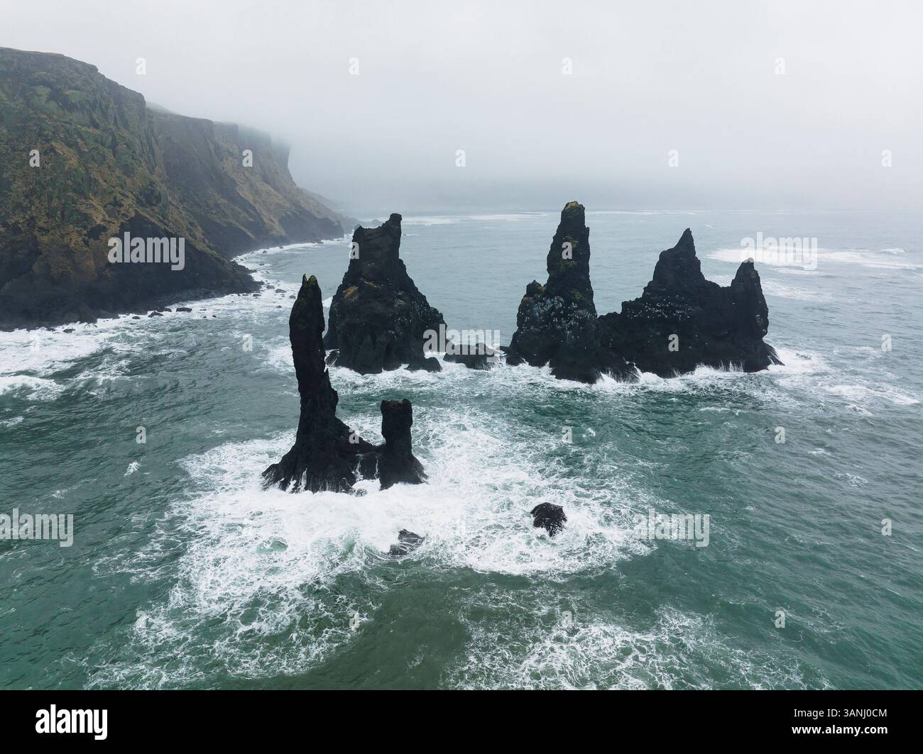 Aerial view of Reynisdrangar rocks, basalt sea stacks situated under ...