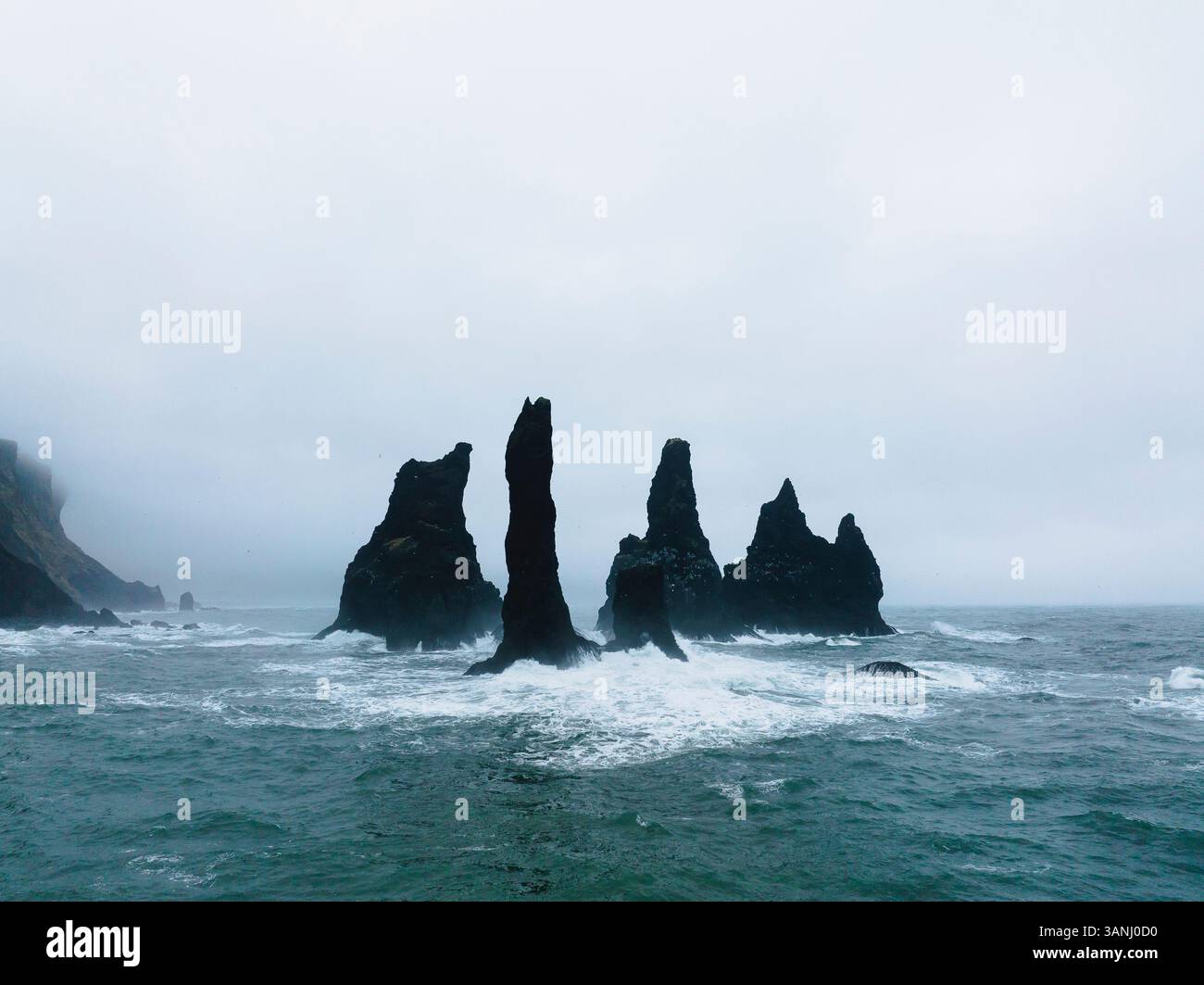 Aerial view of Reynisdrangar rocks, basalt sea stacks situated under ...