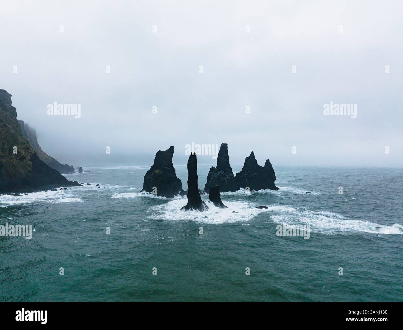 Aerial view of Reynisdrangar rocks, basalt sea stacks situated under ...