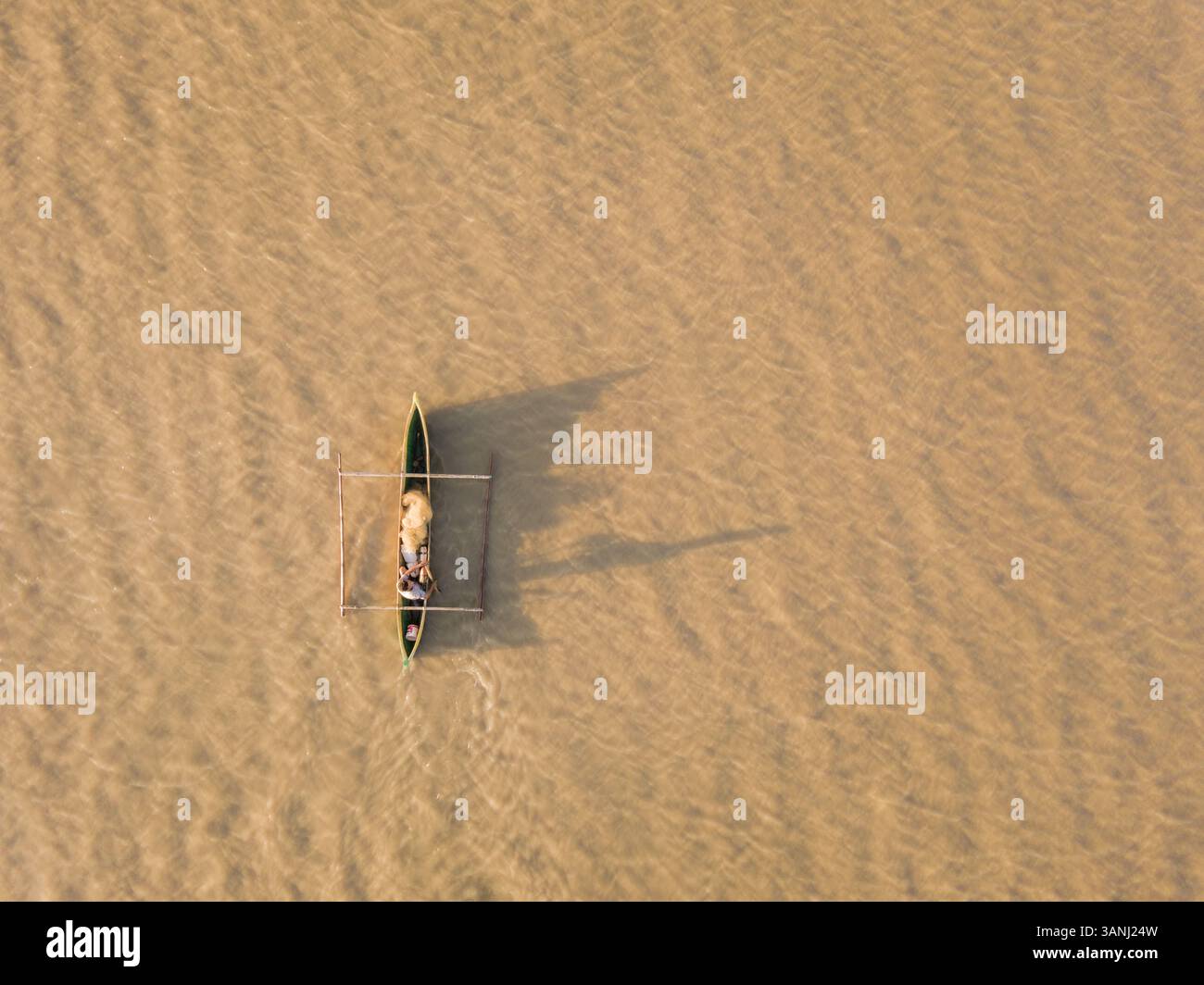 Aerial view of a fisherman and his mirror shadow fishing using a ...