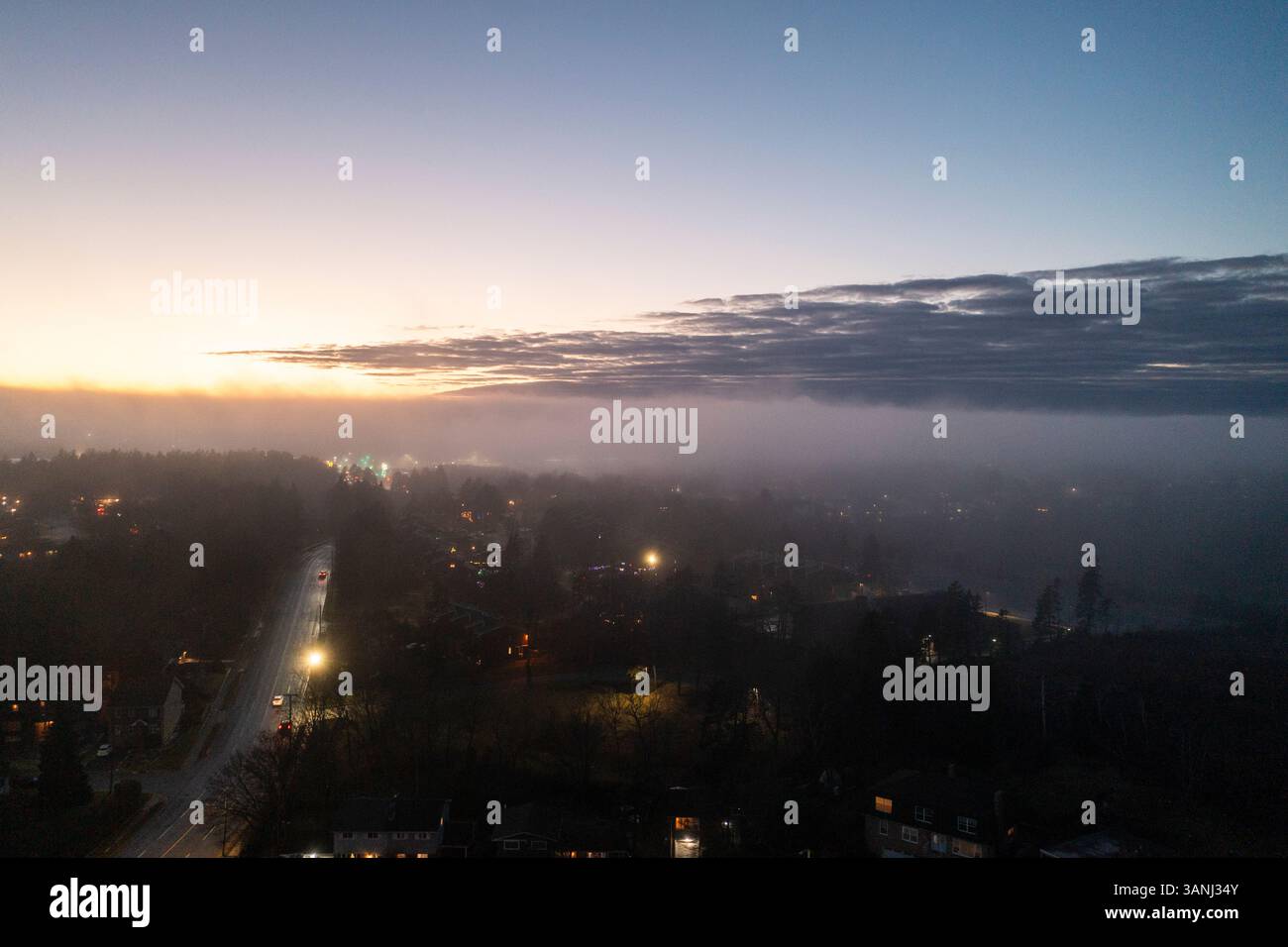 Aerial view of Halifax city skyline at dusk with city lights and fog ...