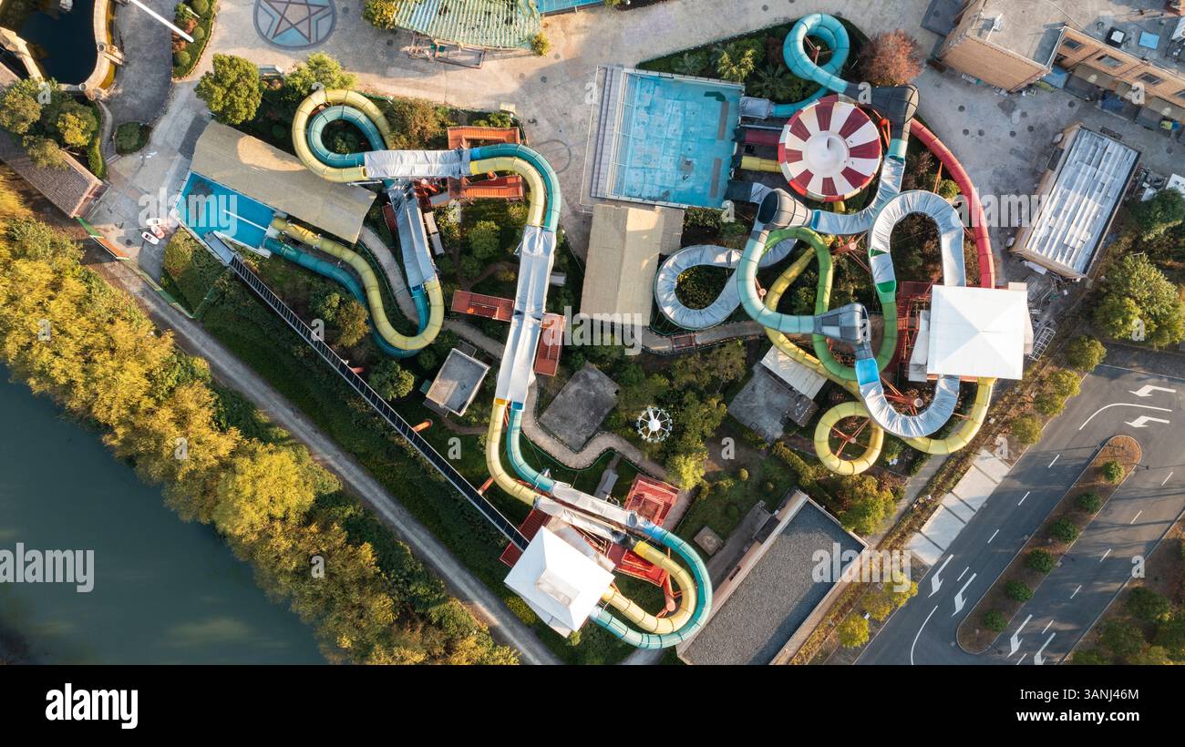 Aerial view of colorful water park with slides and pools surrounded by ...