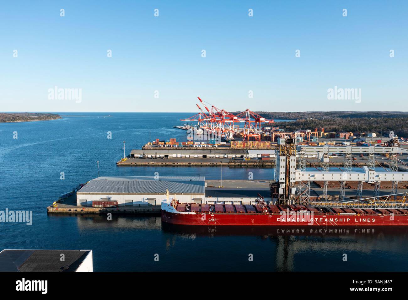 Aerial view of bustling Halifax Seaport with cargo ships and cranes ...