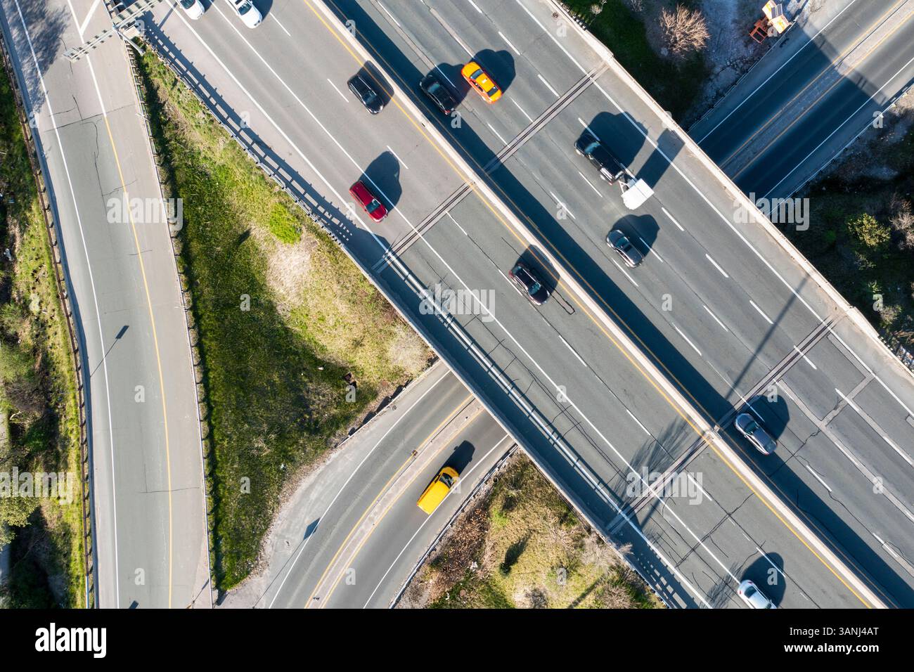 Aerial view of busy highway intersection with cars and urban ...