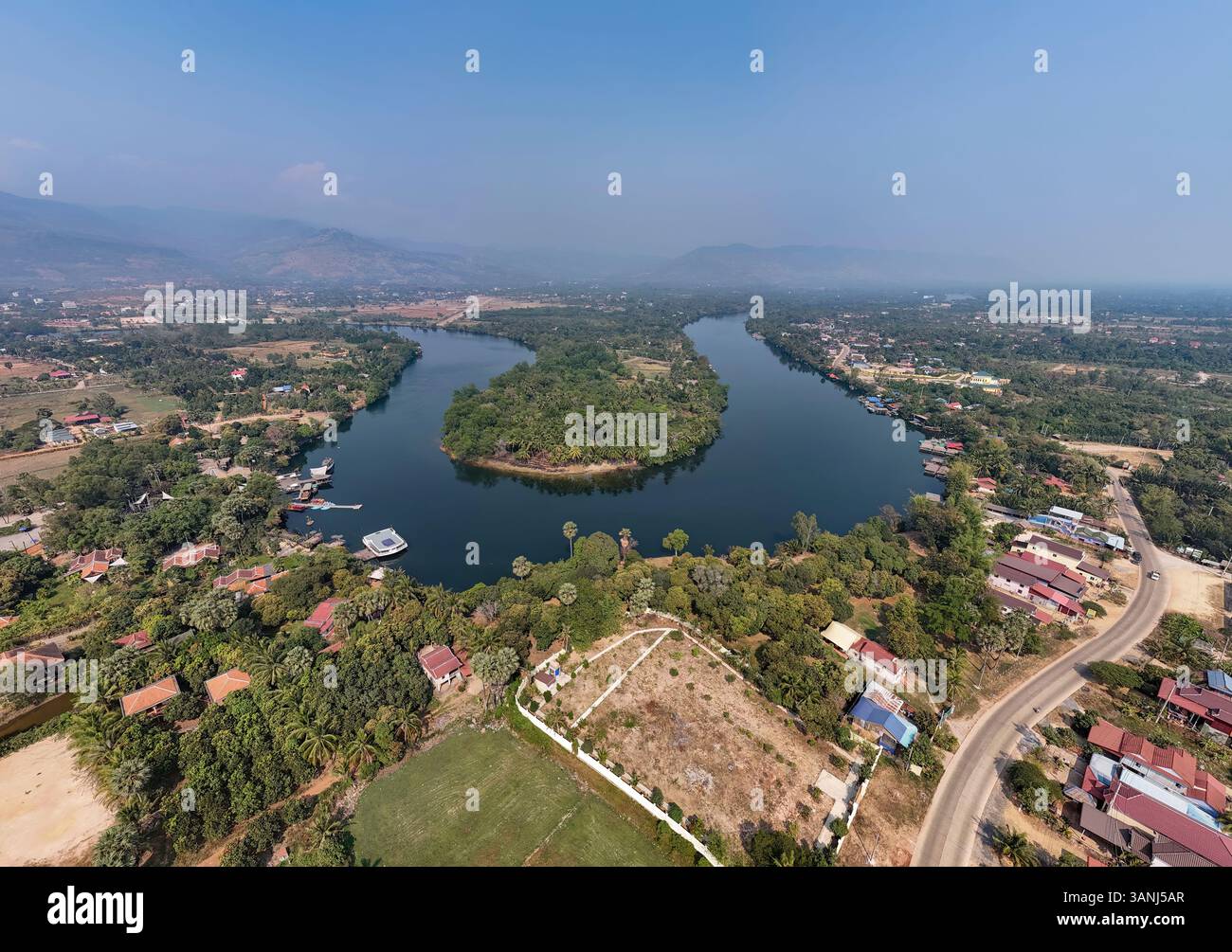 Aerial view of the tranquil Teuk Chhou river winding through lush ...