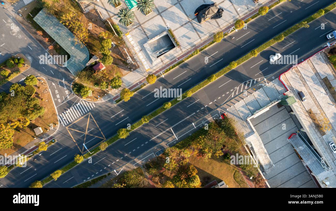 Aerial view of urban intersection with buildings, roads, and trees ...
