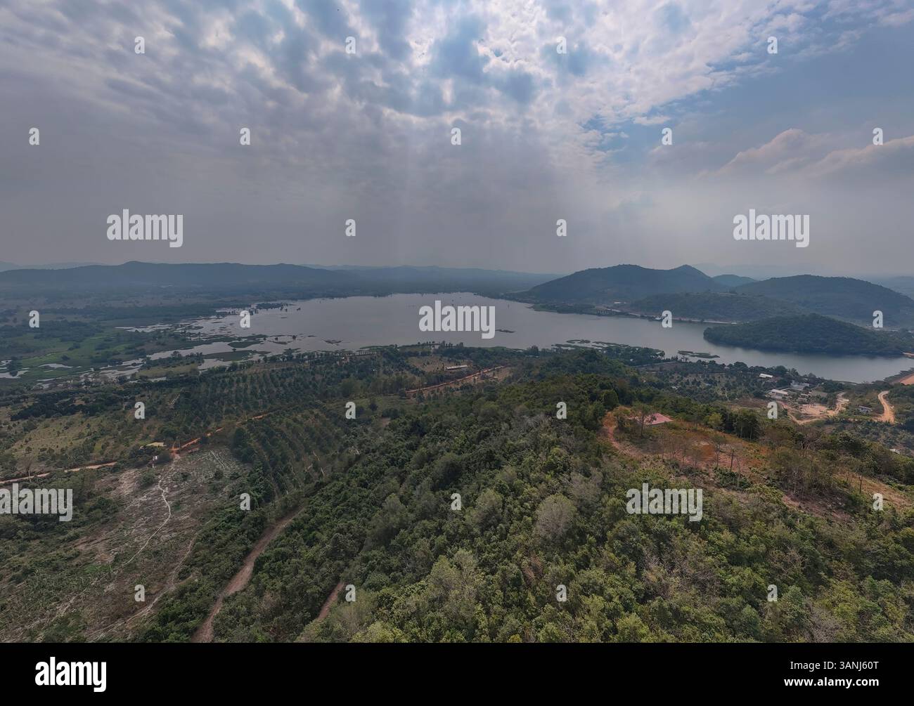 Aerial view of secret lake surrounded by lush hills and serene forest ...
