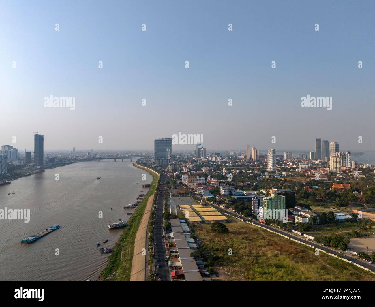 Aerial view of Tonle Sap river with modern buildings and a bustling skyline, Chroy Changvar ...