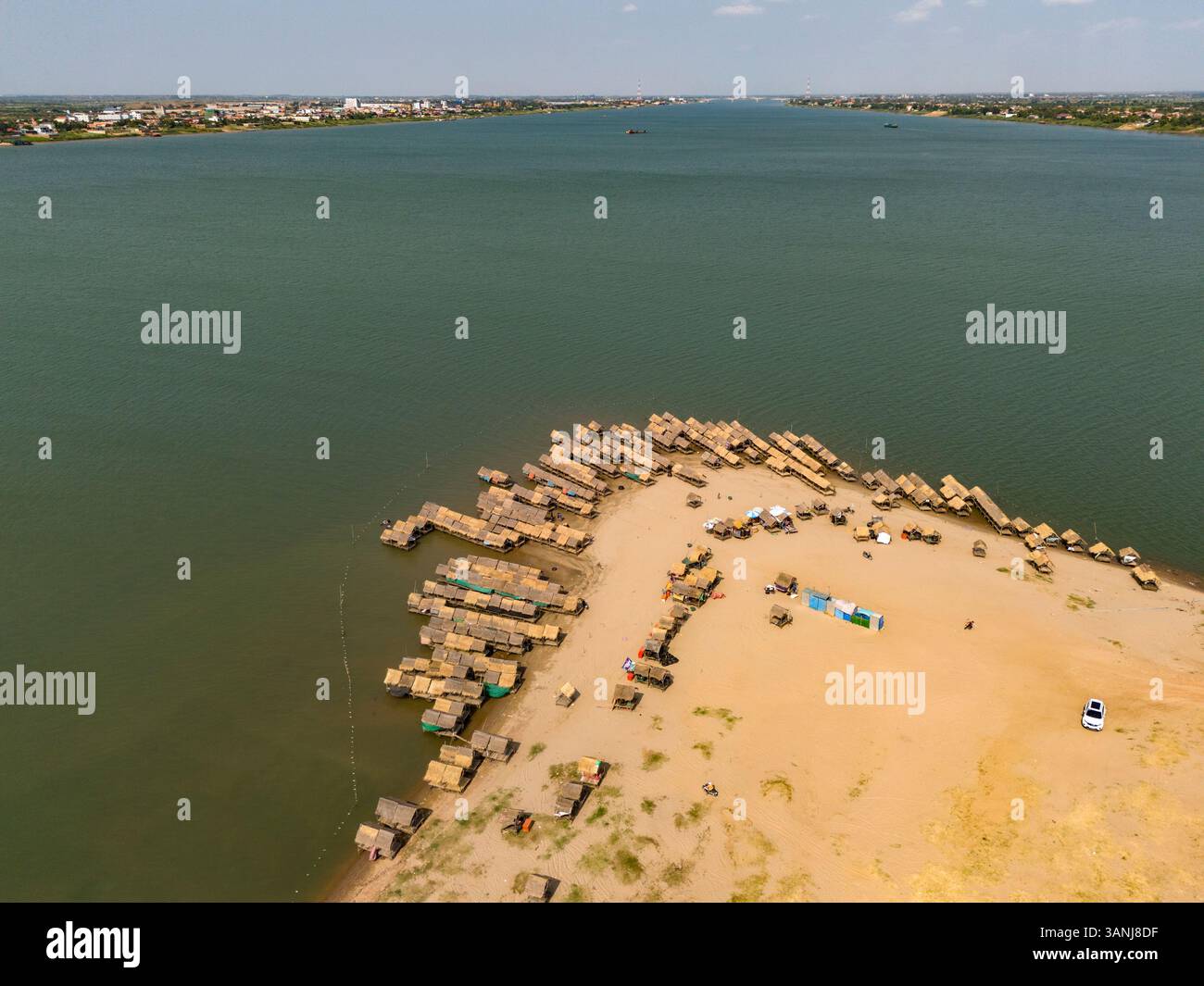 Aerial view of serene Silk Island with traditional huts and a winding ...