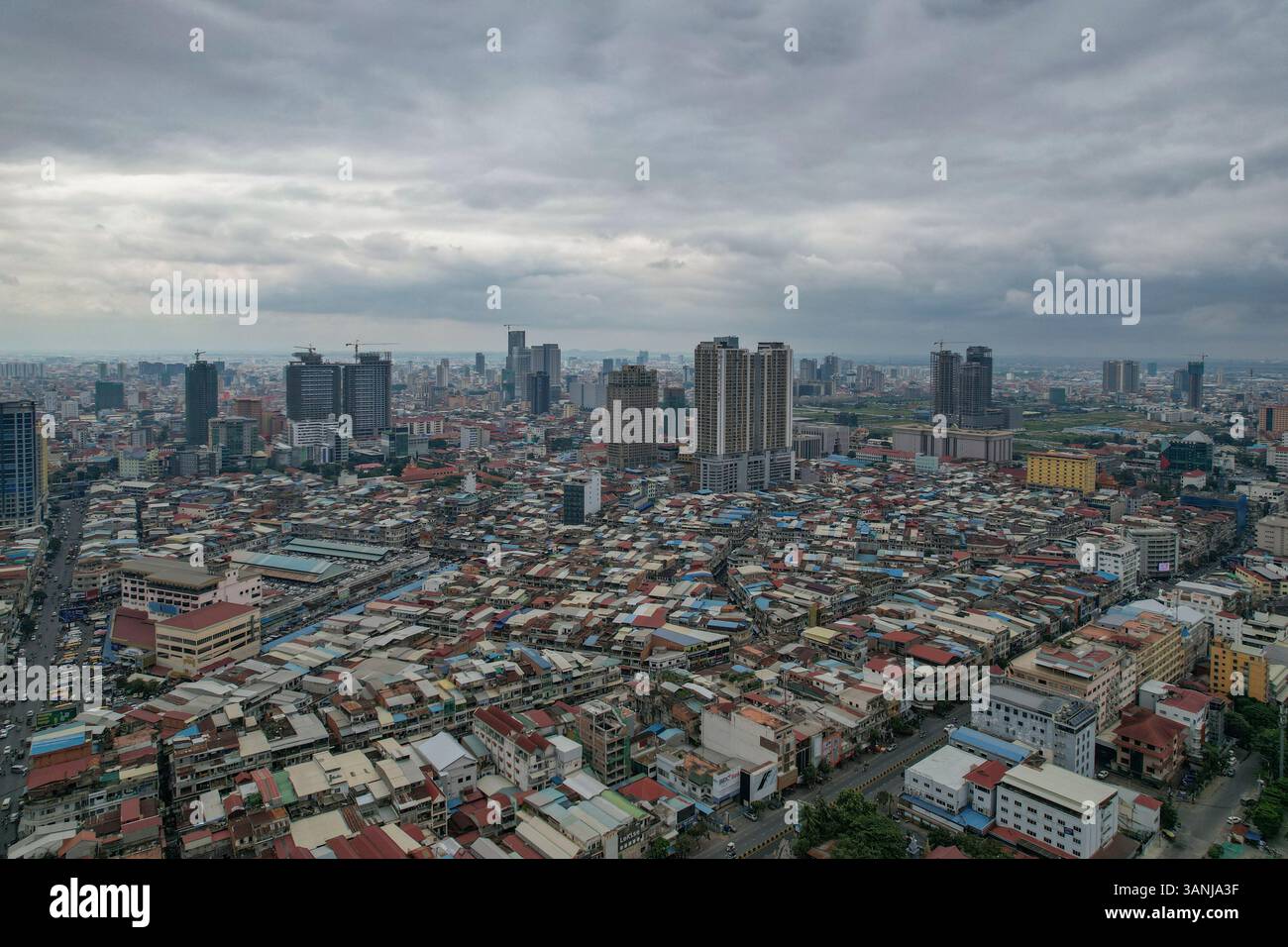 Aerial view of a bustling urban landscape with dense skyscrapers under ...