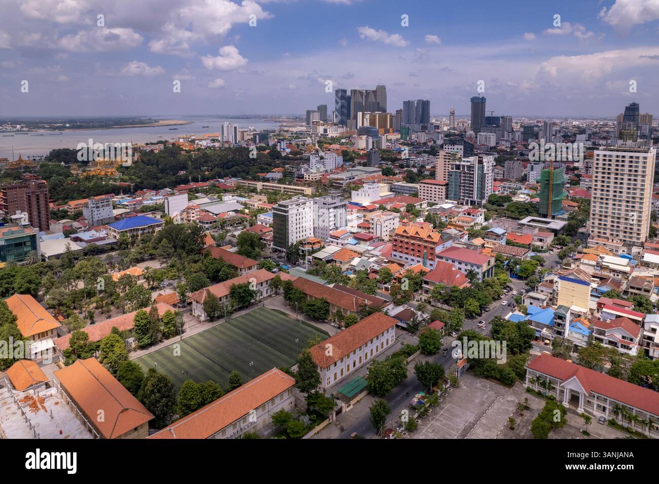Aerial view of urban landscape with modern buildings and a soccer field ...