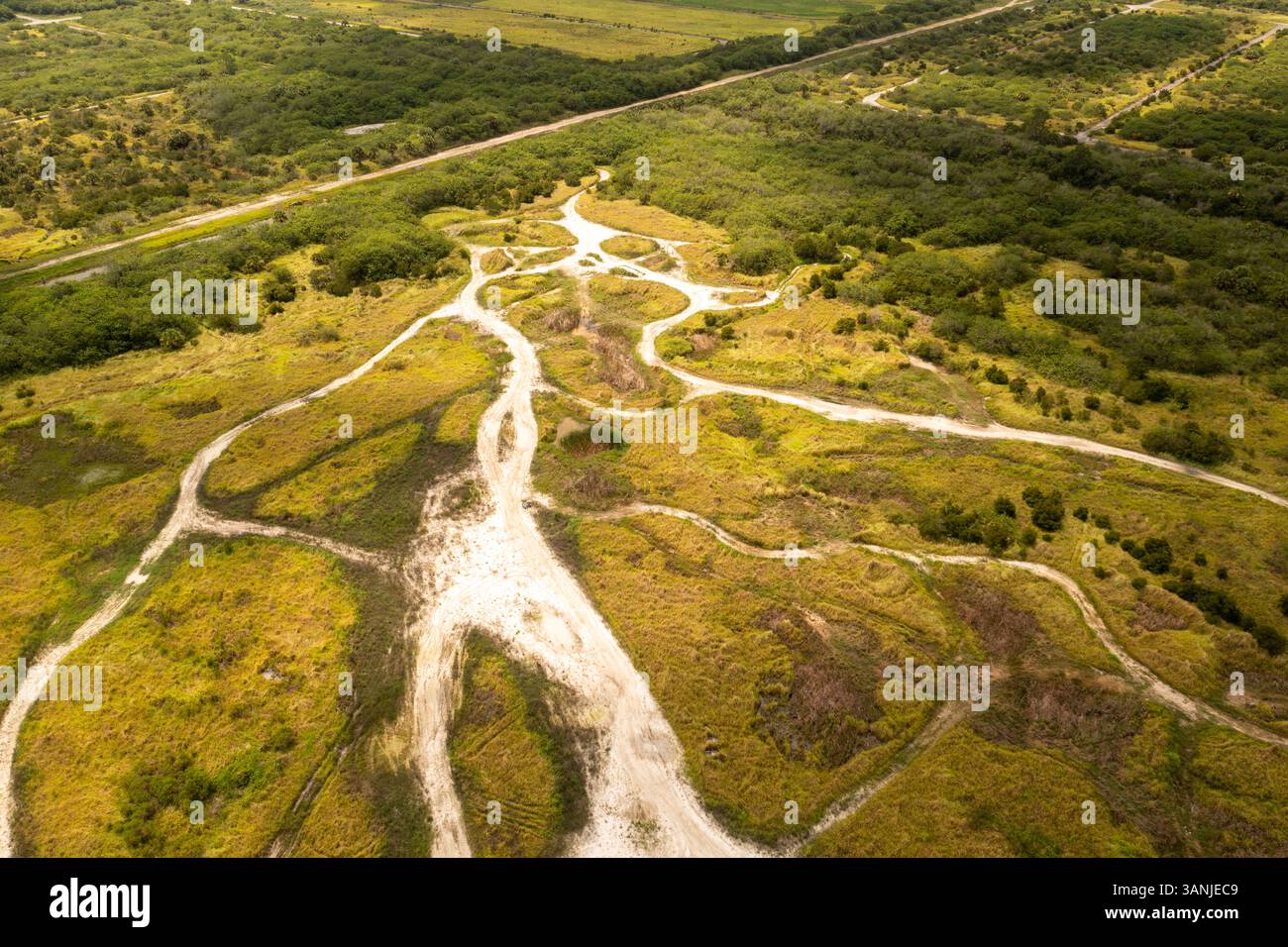 Aerial view of the undeveloped landscape with winding ATV trails and ...