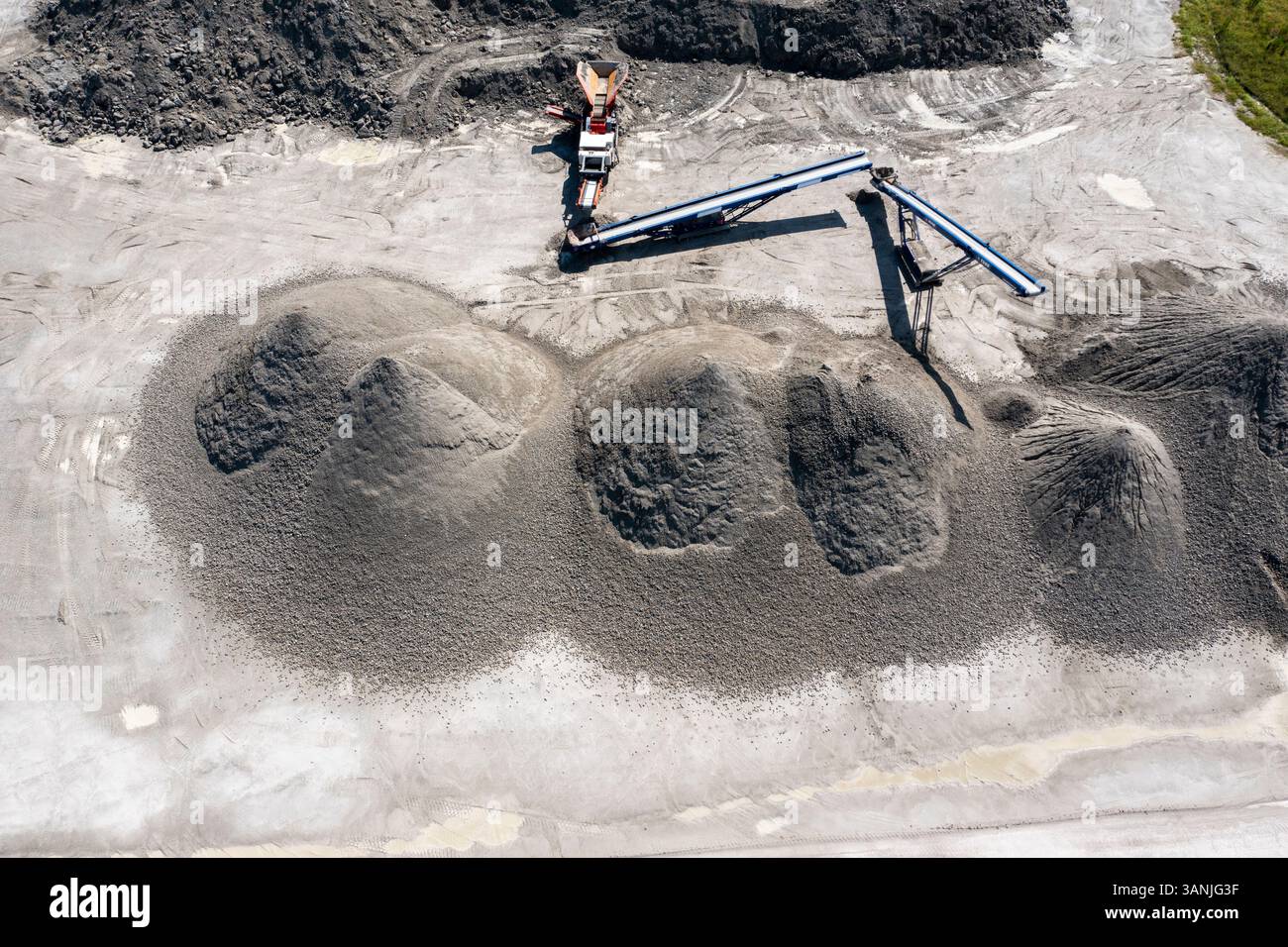 Aerial view of Sunshine Mine with gravel piles and industrial machinery ...