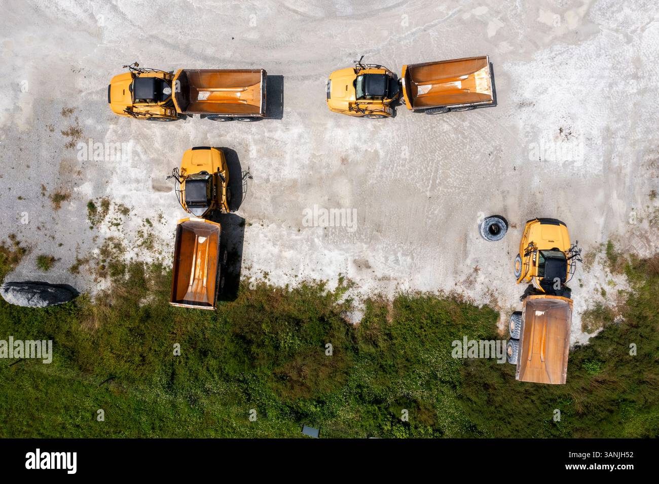 Aerial view of construction site with heavy machinery and trucks at Stavola Aggregate Supply ...