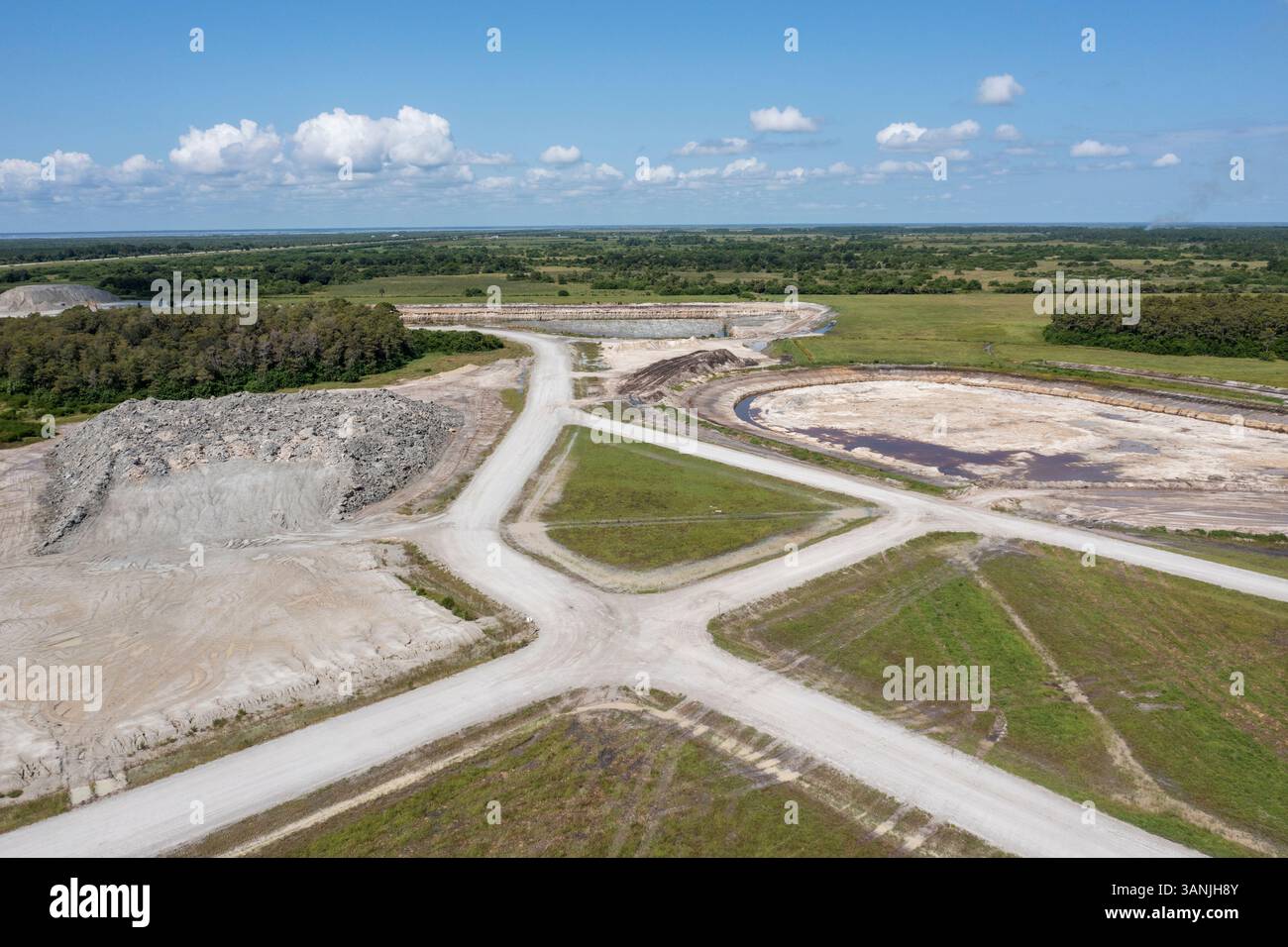 Aerial view of the industrial Sunshine Mine with green terrain and ...