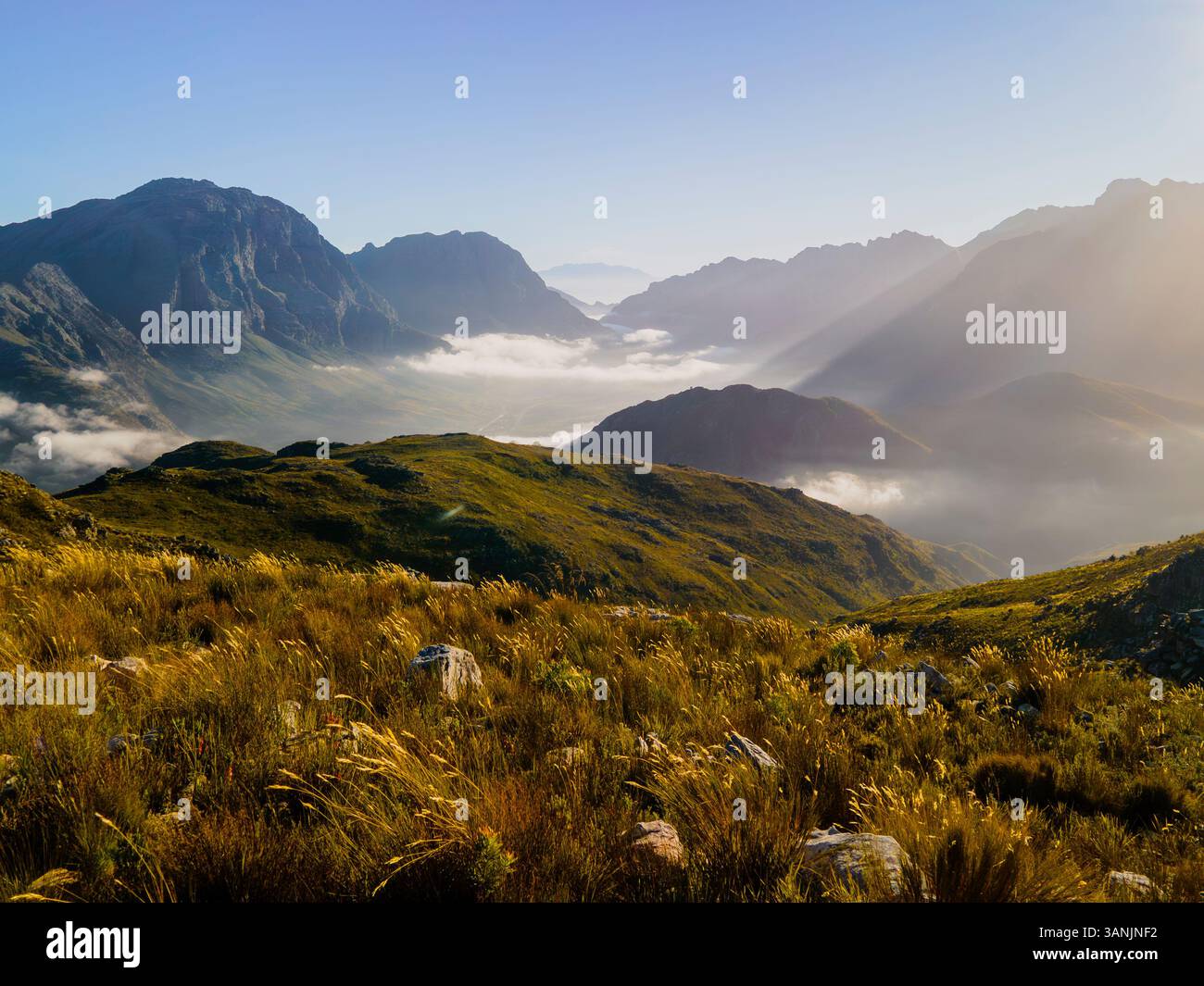Aerial view of majestic mountains and a serene valley under beautiful ...