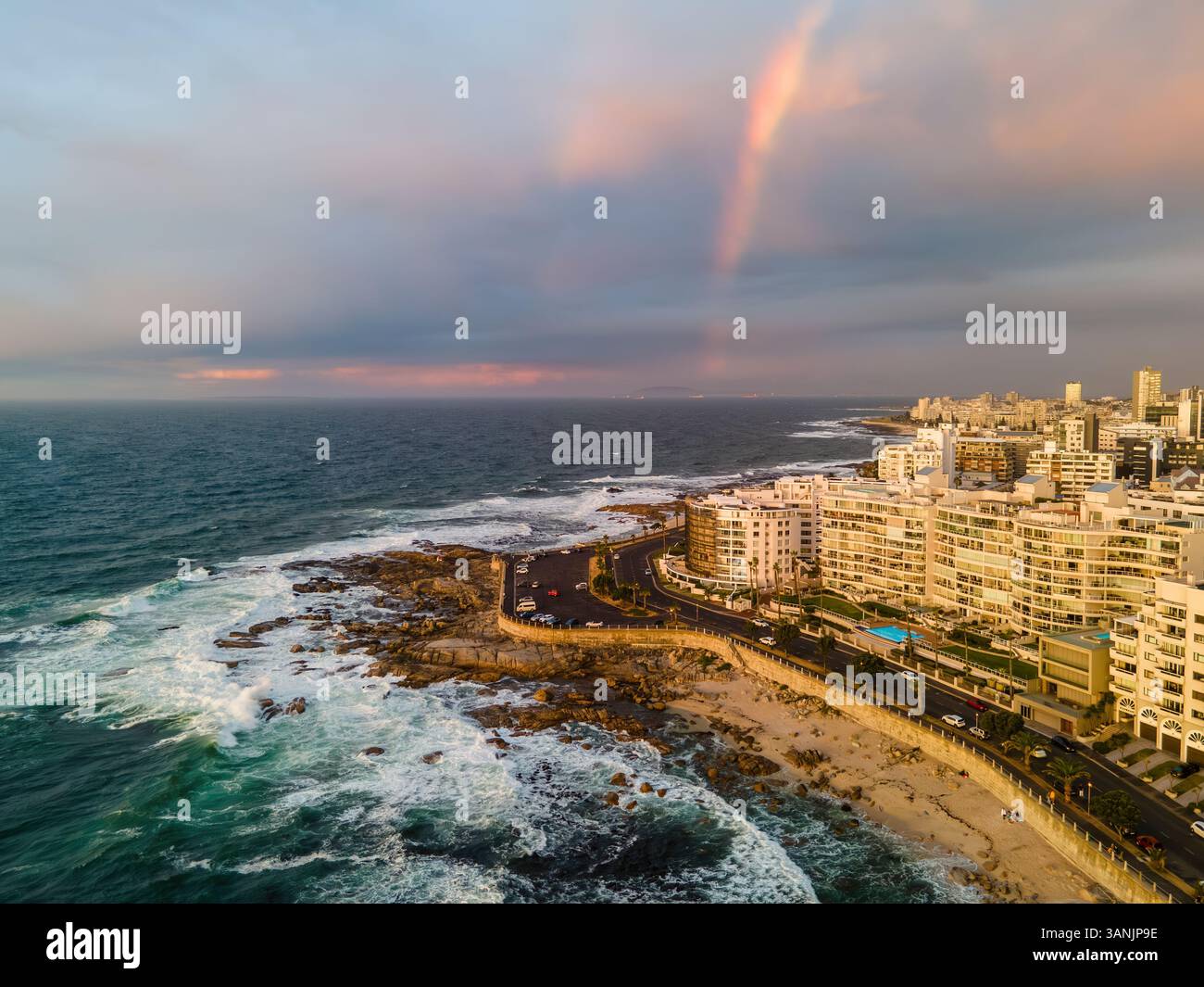 Aerial view of rainbow at sunset on Sea Point Promenade with Lion’s ...