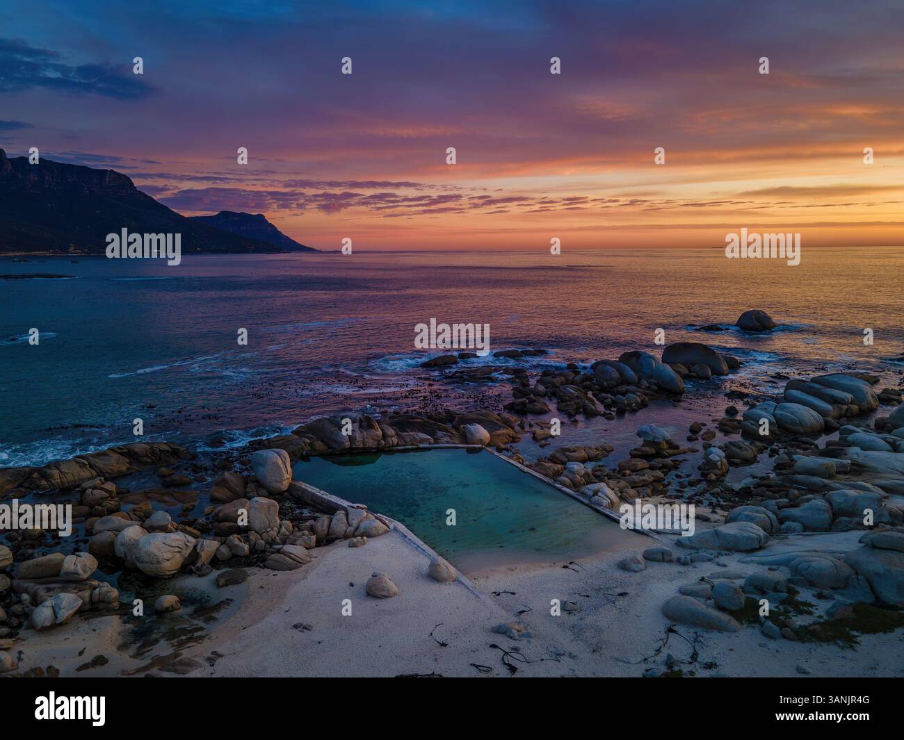 Aerial view of Maidens Cove tidal pool at sunset with Atlantic Ocean in ...