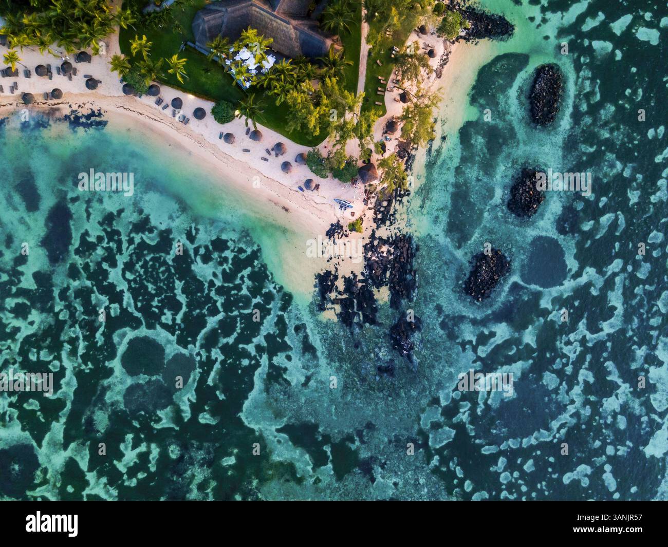 Aerial view of Pointe aux Canonniers coastline and clear Indian Ocean ...