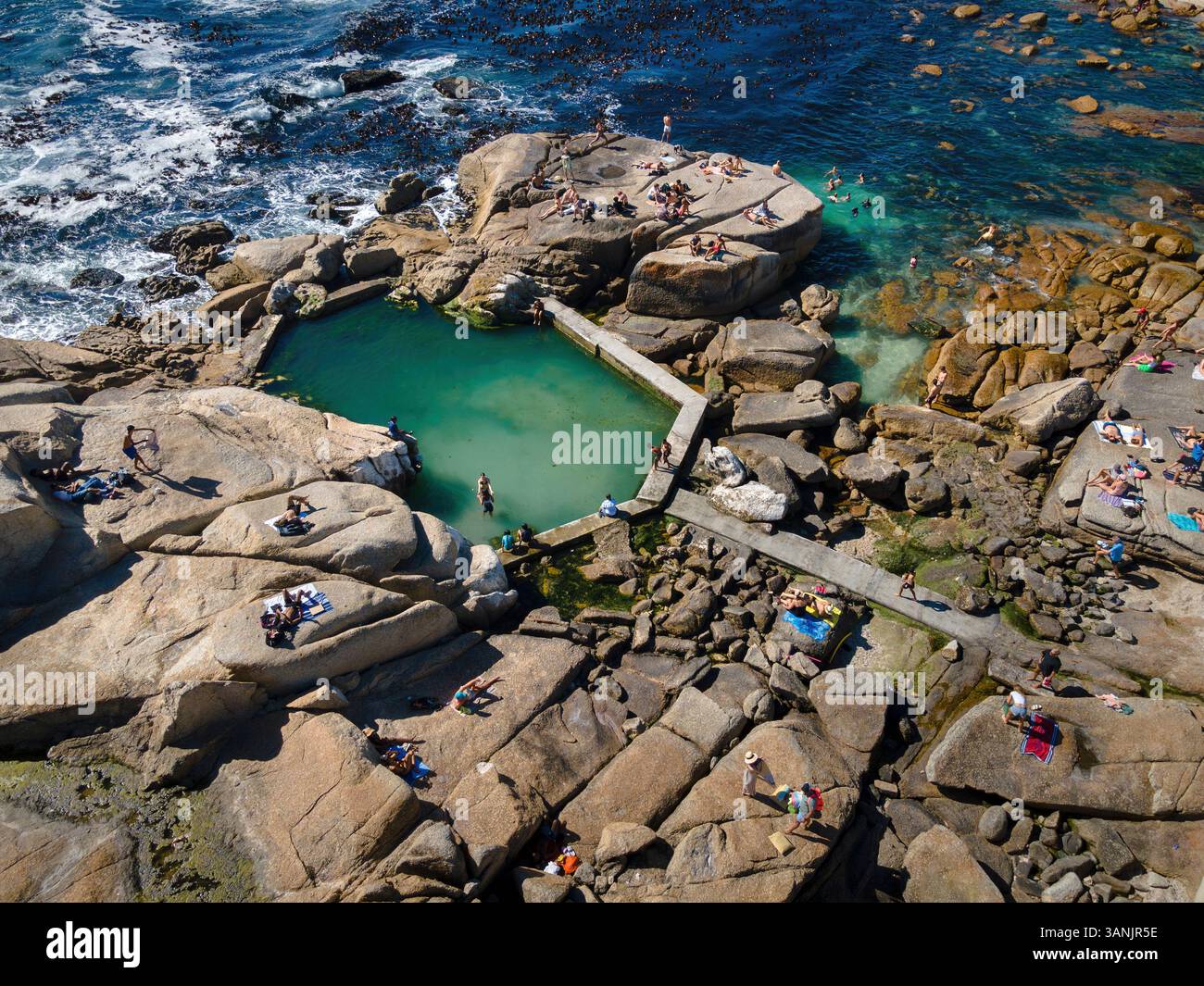 Aerial view of swimmers and beach goers at Saunder’s Rock tidal pool in ...