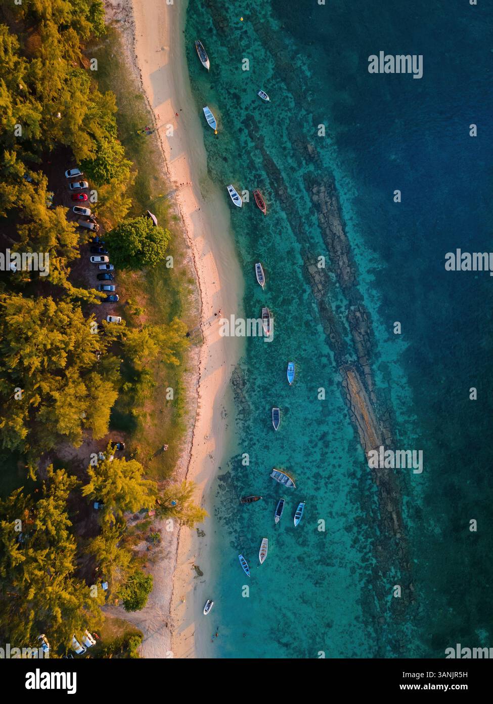 Aerial view of small fishing boats on Balaclava Public Beach at sunset ...