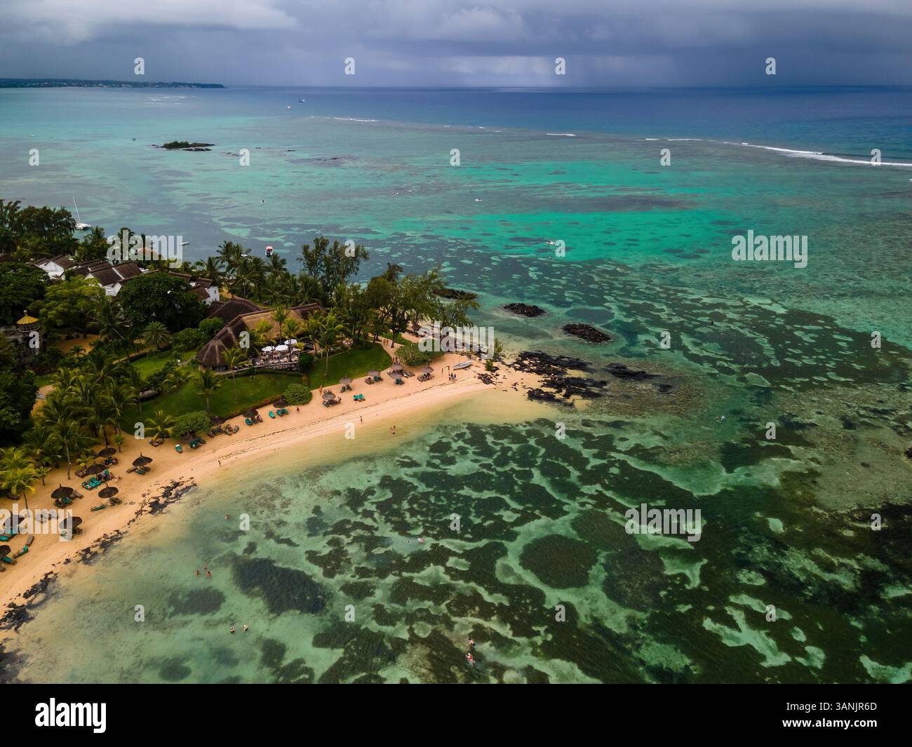 Aerial view of Pointe aux Canonniers coastline and clear Indian Ocean ...