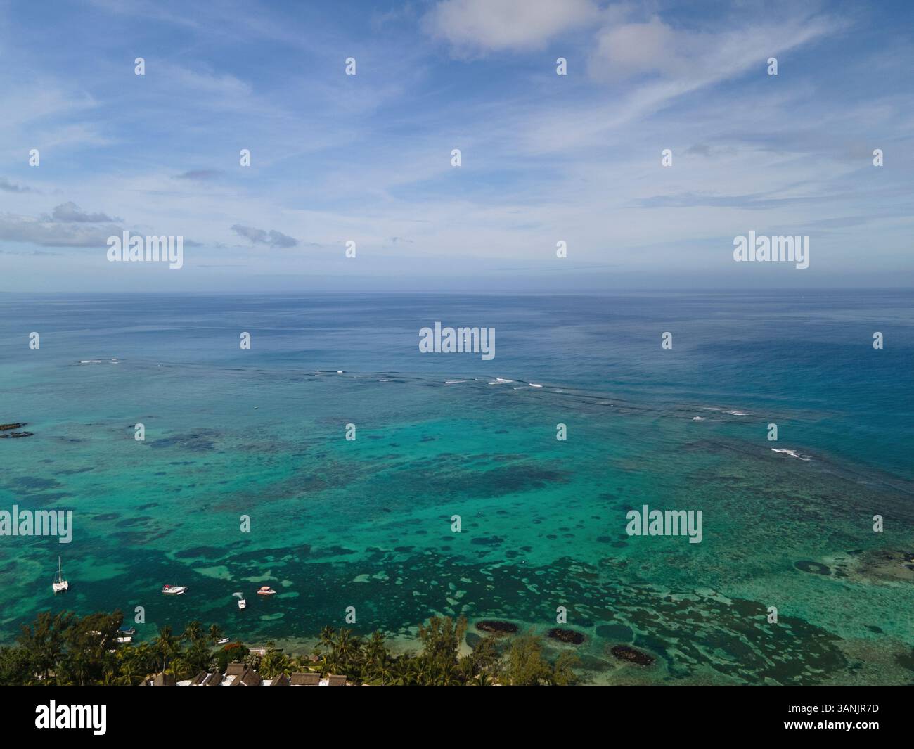 Aerial view of Pointe aux Canonniers reefline and clear Indian Ocean ...