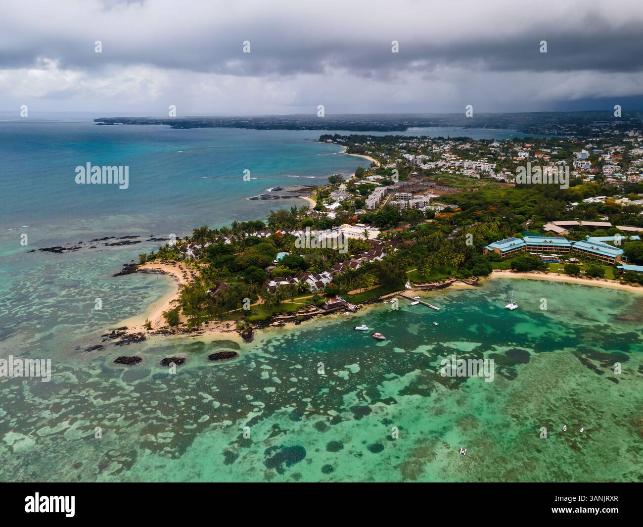 Aerial view of Pointe aux Canonniers coastline and clear Indian Ocean ...