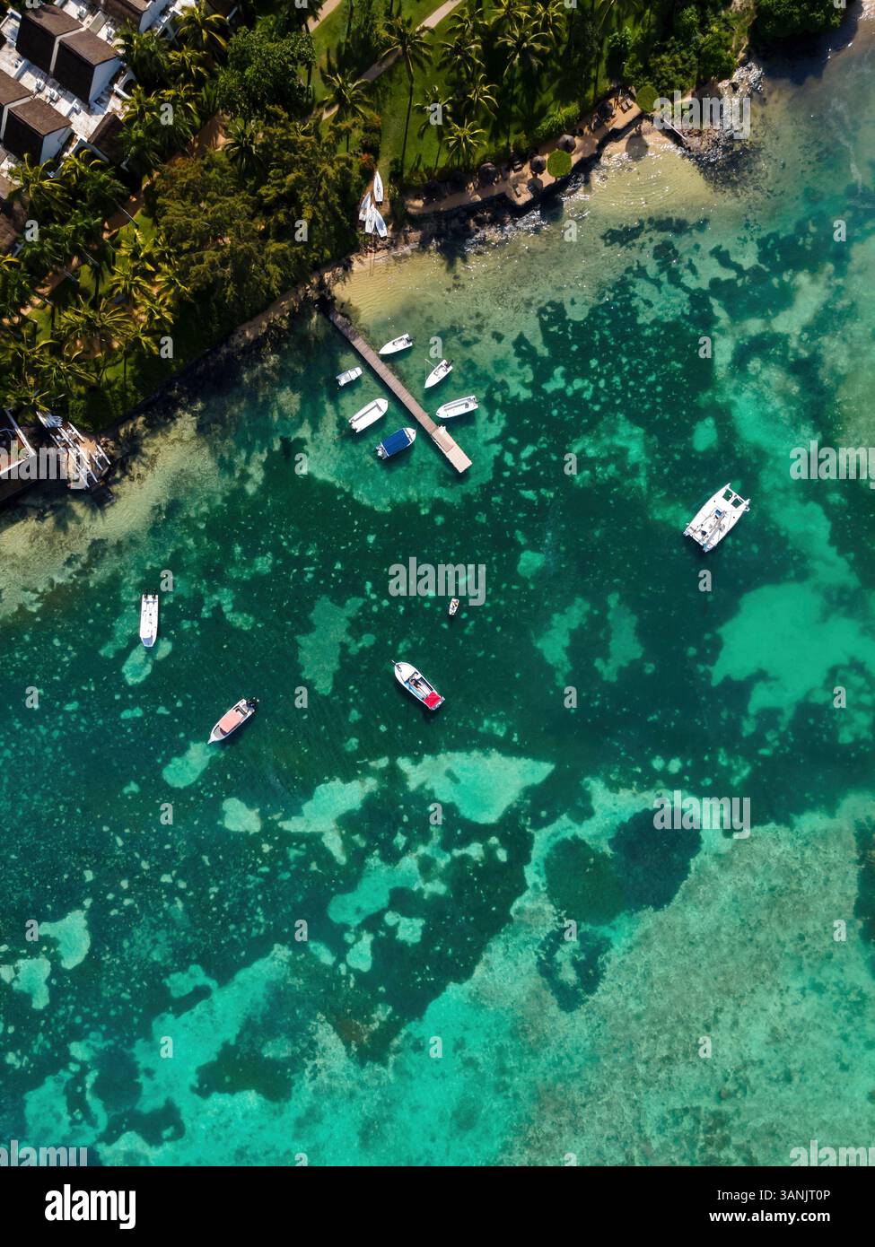 Aerial view of dock at Pointe aux Canonniers coastline and clear Indian ...