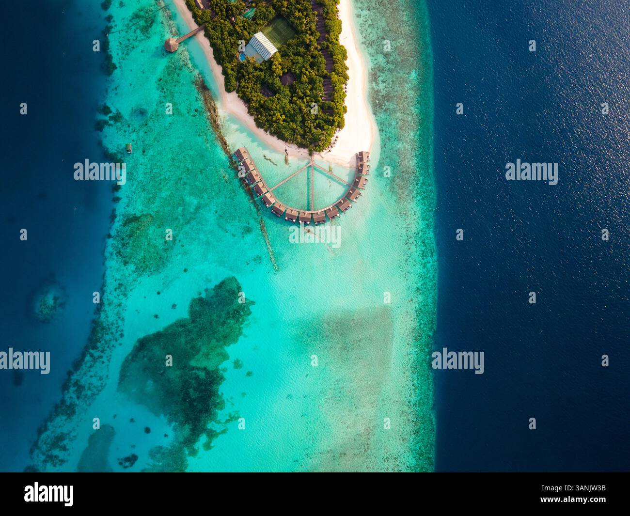 Aerial view of tropical island with a luxury resort on the beach front ...