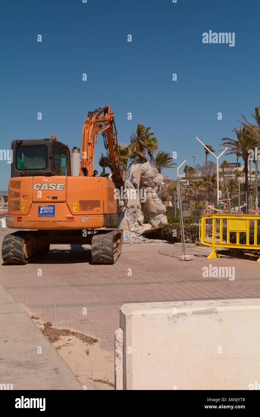 Construction workers using JCB machines to remove heavy concrete light ...