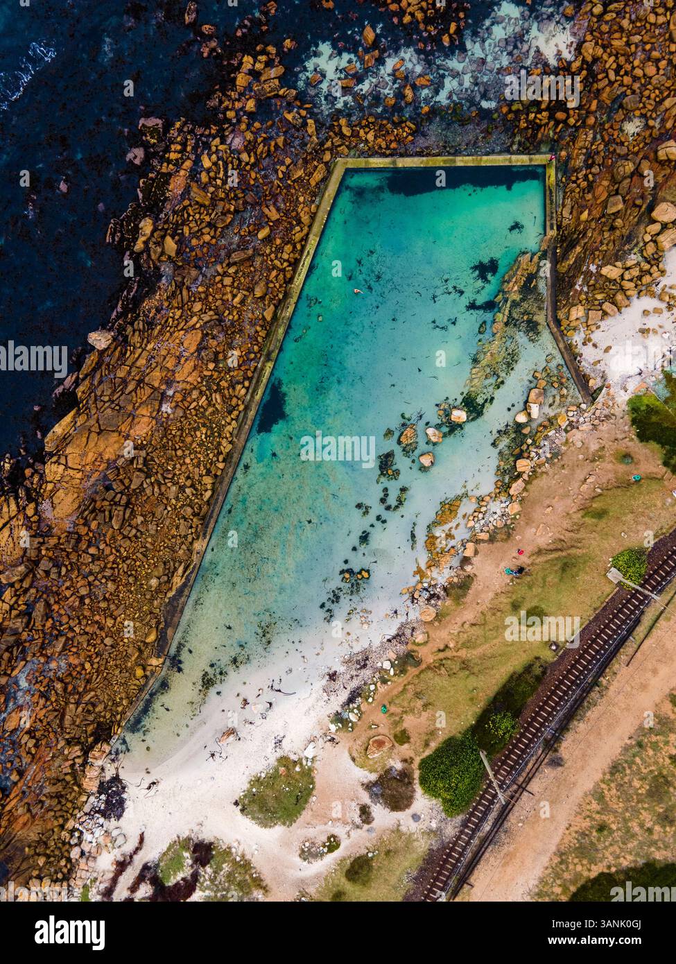Aerial view of Glencairn tidal pool in summertime along the shoreline ...