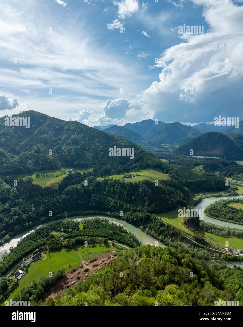 Aerial view of the serene Enns River winding through lush green valleys ...