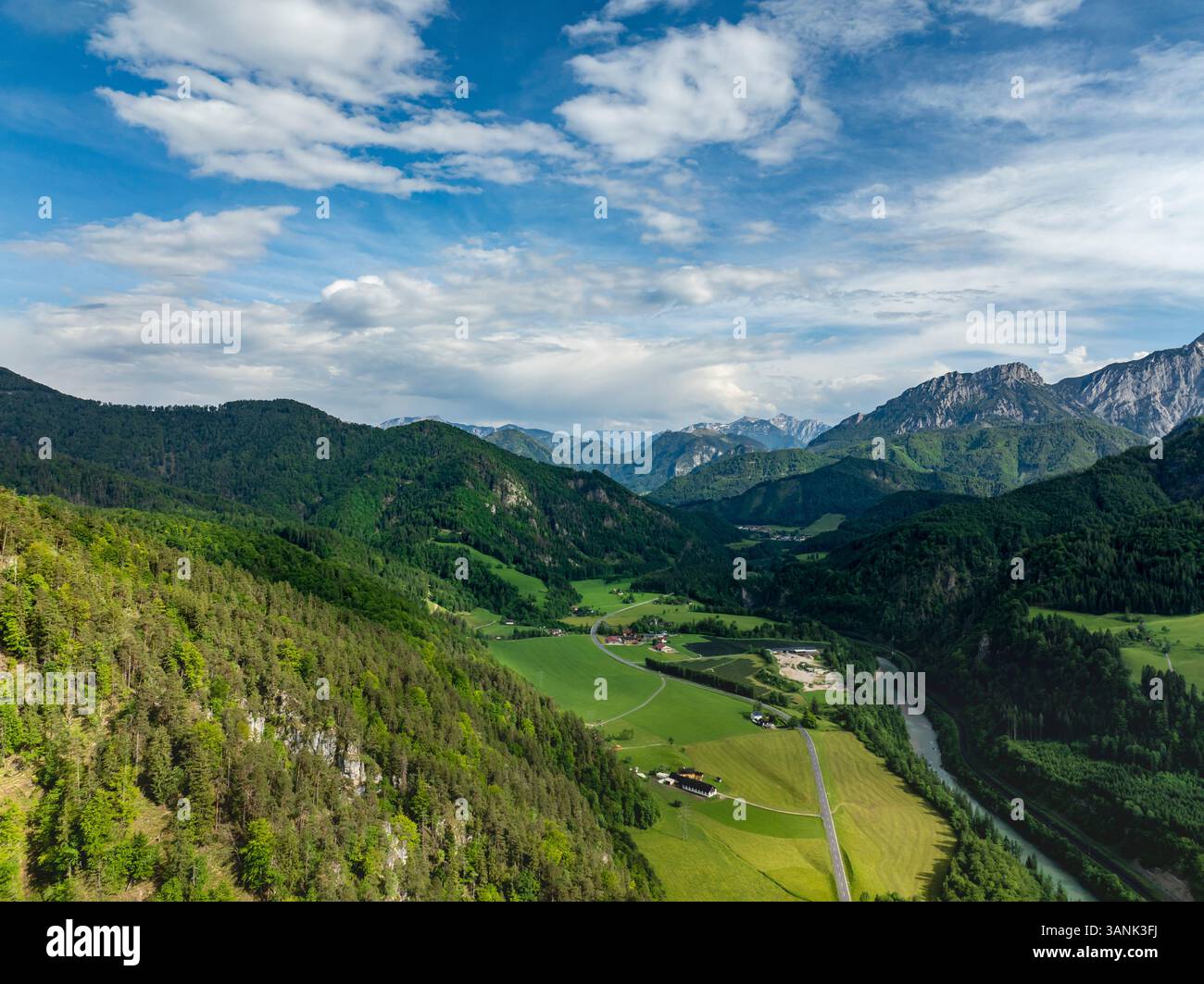 Aerial view of the serene Enns River flowing through lush green valleys ...