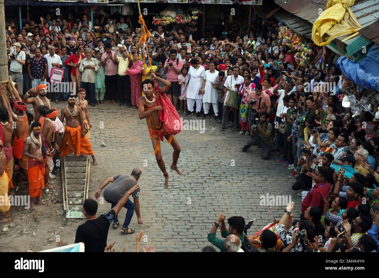 Chadak festival, in Kolkata, India People wait to get offerings from a ...