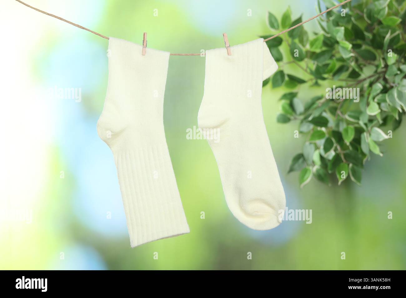 Pair of socks hanging on washing line outdoors Stock Photo - Alamy