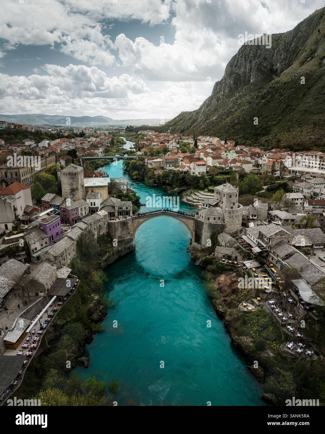 Aerial view of Mostar cityscape with historic stone bridge over Neretva ...